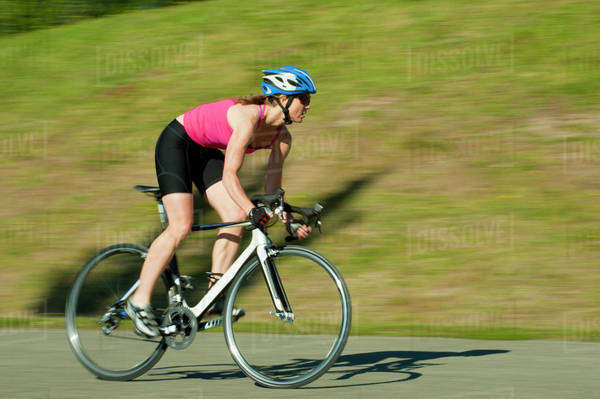 Caucasian woman riding bicycle in park - Royalty-free Stock Photo ...