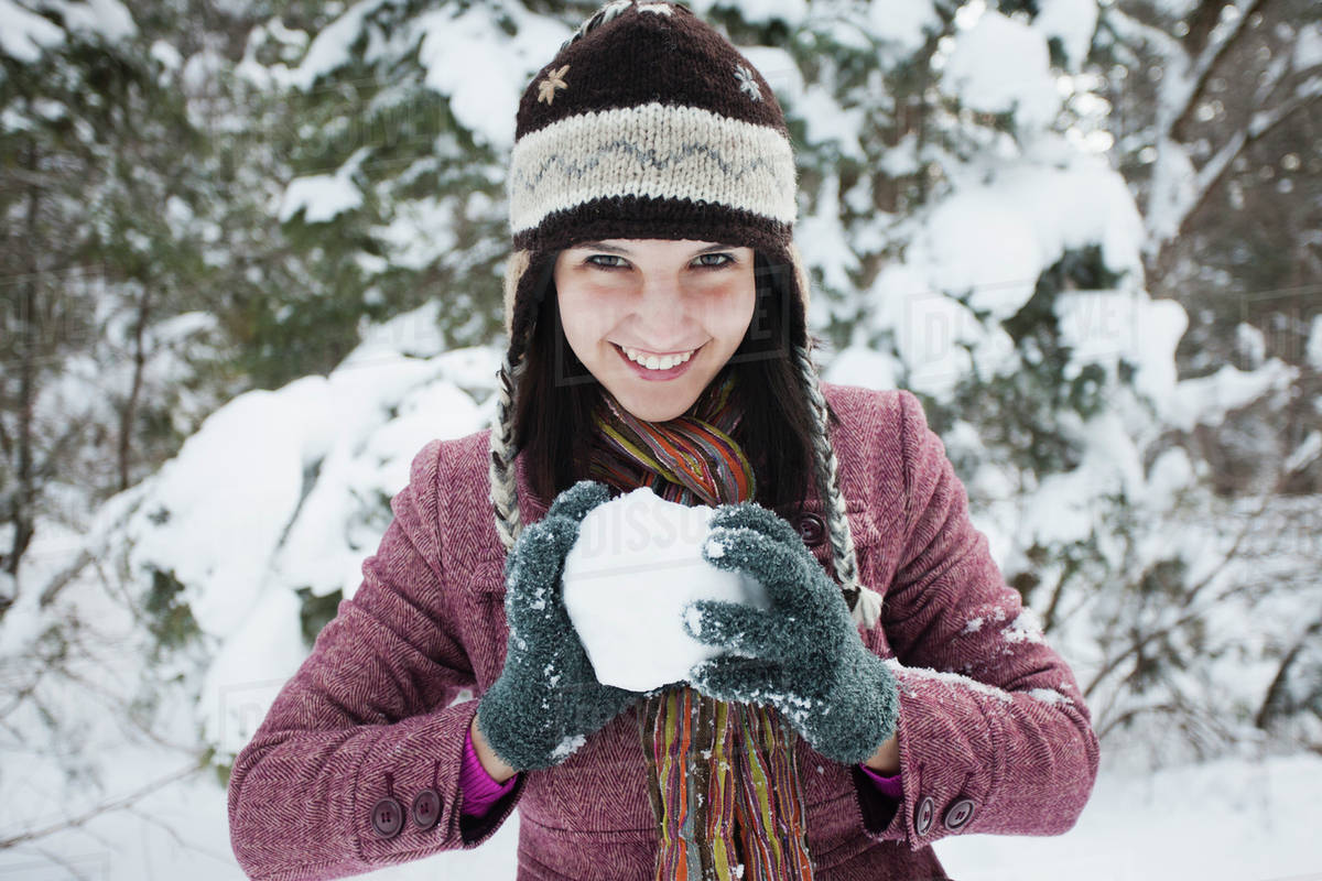 Caucasian woman making snowball - Royalty-free Stock Photo | Dissolve