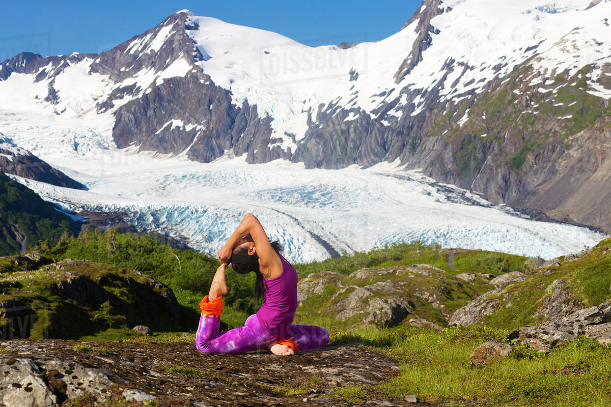 Korean woman practicing yoga with mountain in background - Royalty-free ...