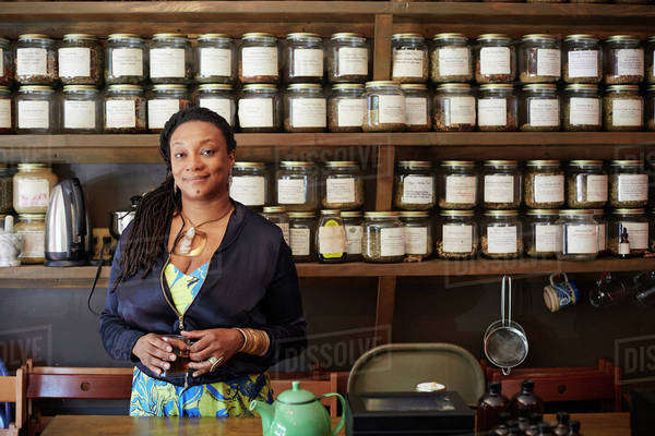 Black woman drinking tea in tea shop - Stock Photo - Dissolve