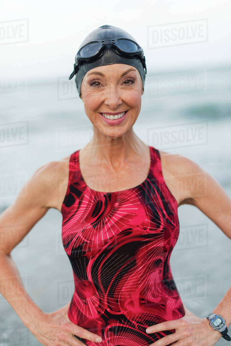 Caucasian swimmer smiling on beach - Royalty-free Stock Photo | Dissolve