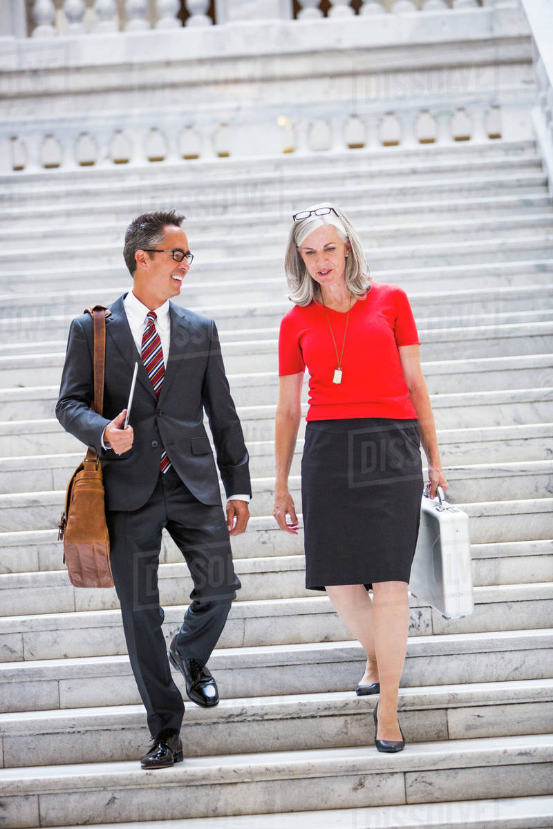 Business people talking on steps - Stock Photo - Dissolve