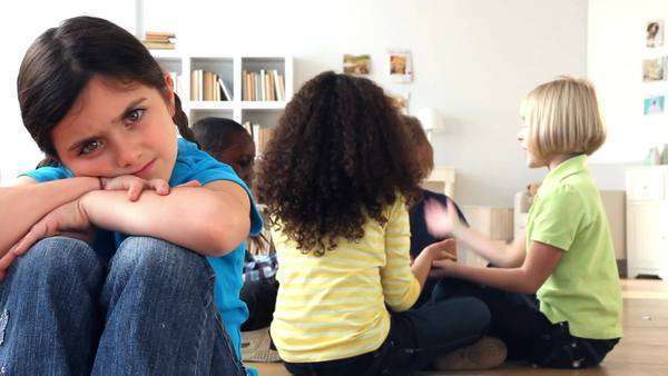 Lonely girl left out of game - Stock Video Footage - Dissolve