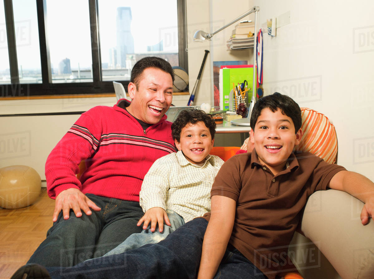 Hispanic father and sons laughing - Stock Photo - Dissolve