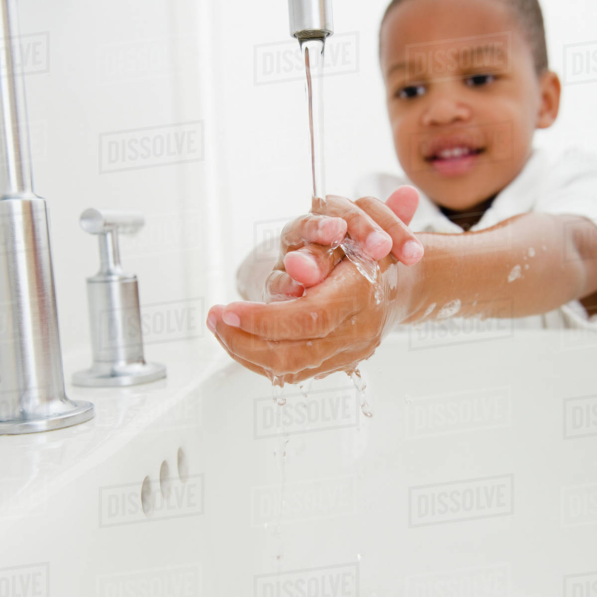 African American boy washing hands - Royalty-free Stock Photo | Dissolve