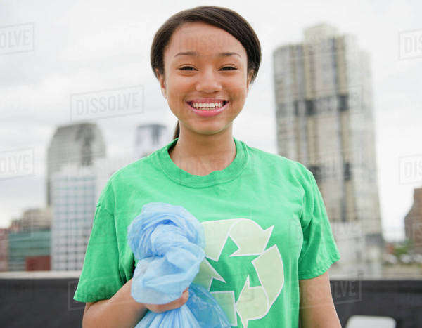 Smiling mixed race teenage girl wearing recycling t-shirt - Stock Photo ...
