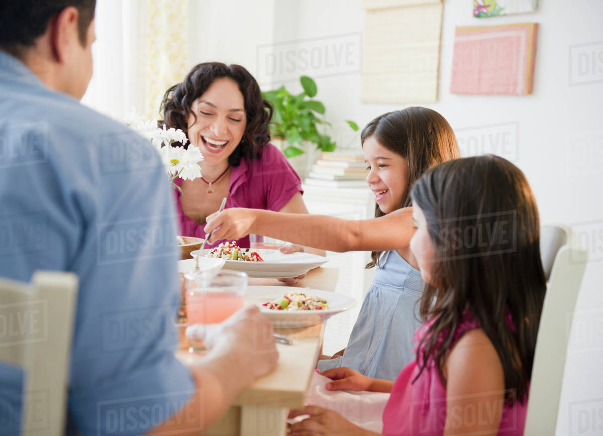Laughing family having dinner together - Stock Photo - Dissolve