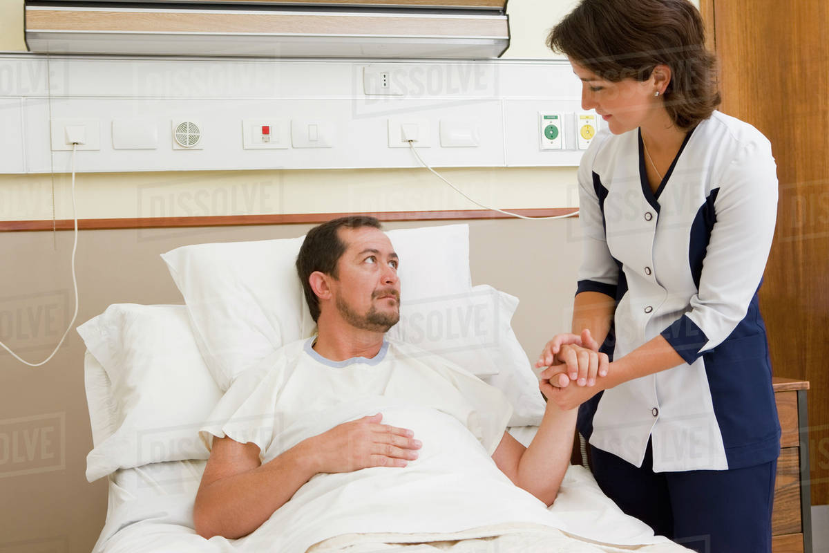Nurse comforting patient in hospital room - Royalty-free Stock Photo ...
