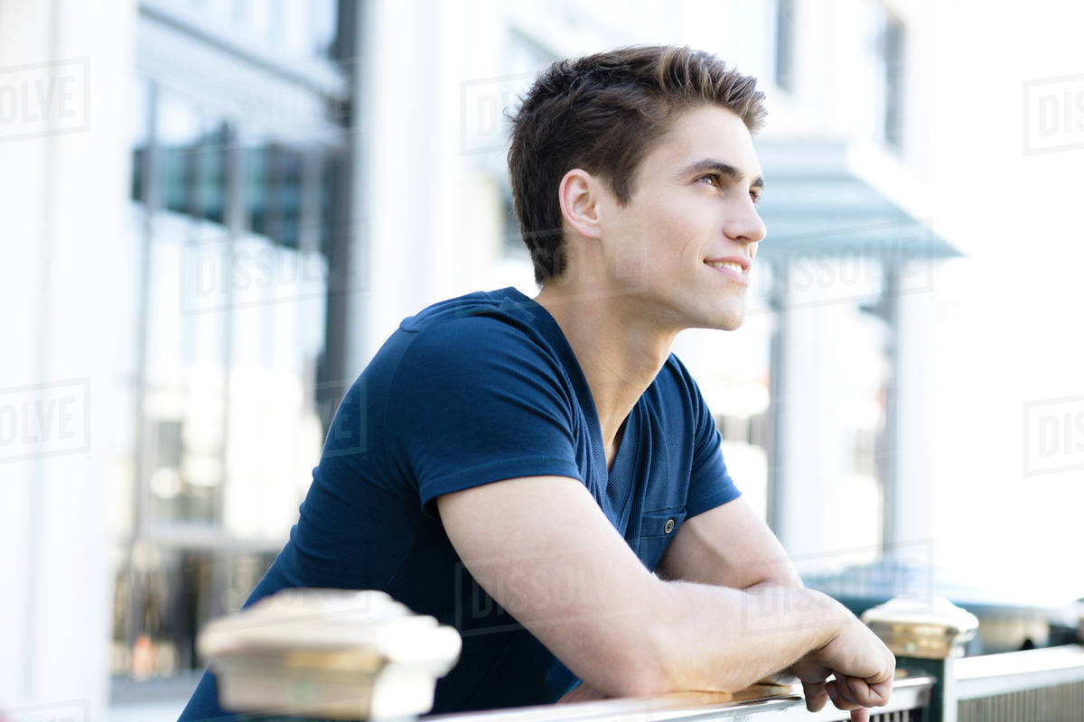 Smiling Caucasian man leaning on railing - Royalty-free Stock Photo ...