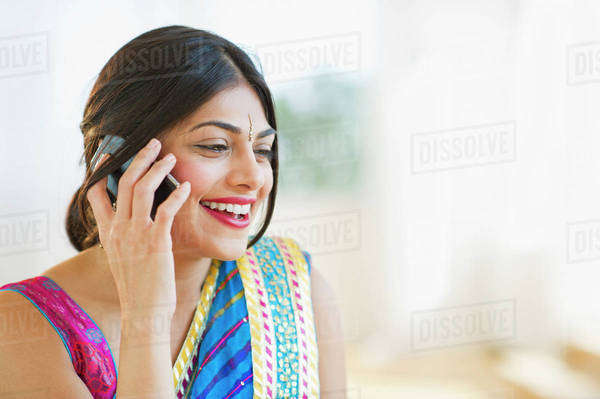 Indian woman in traditional Indian clothing talking on cell phone ...
