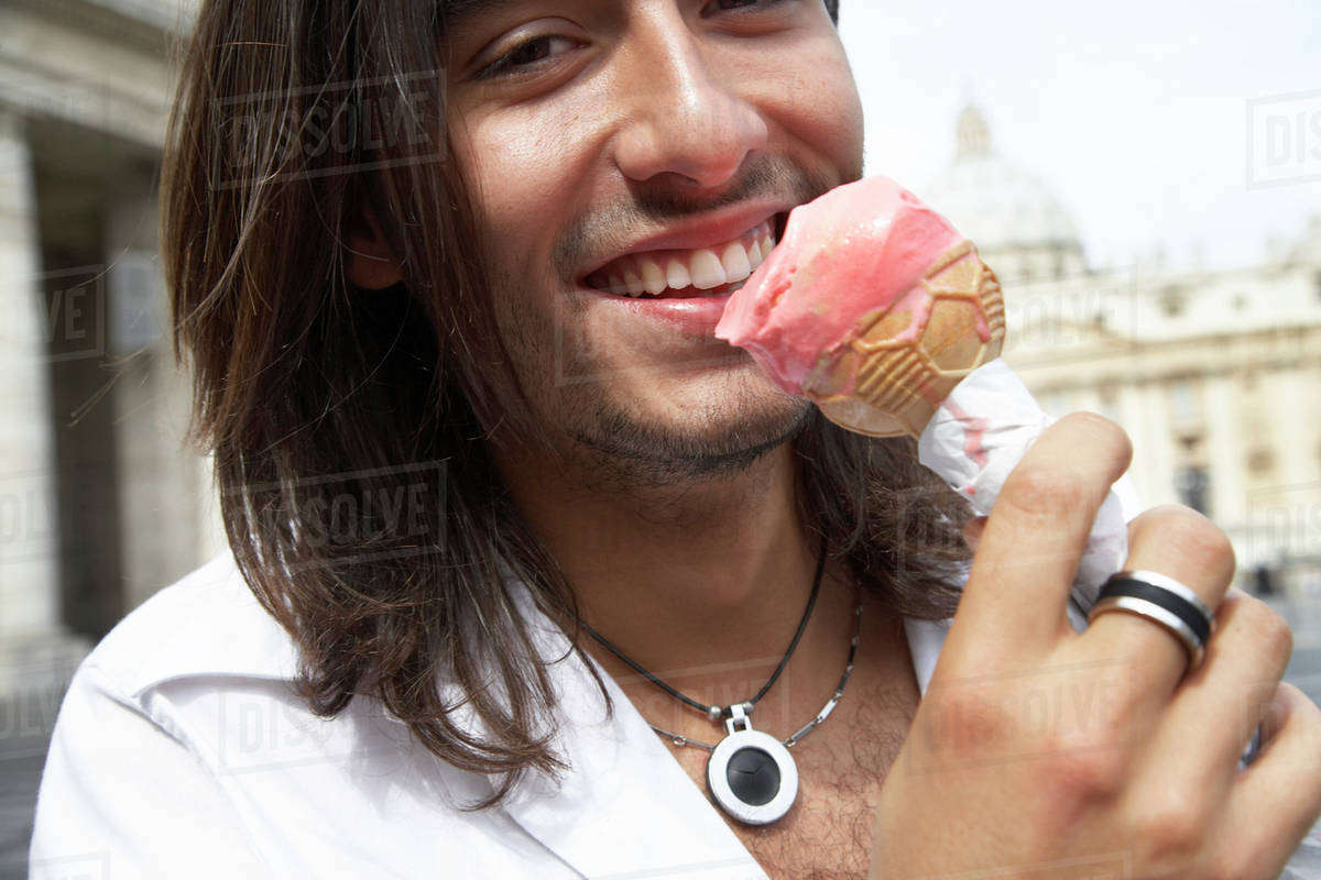 Italian man eating ice cream cone - Royalty-free Stock Photo | Dissolve