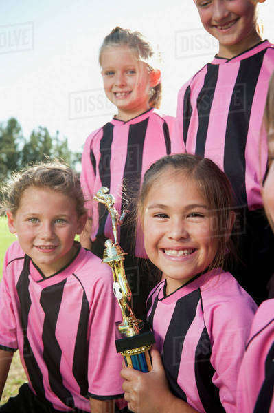Smiling girl soccer players posing with trophy - Royalty-free Stock ...