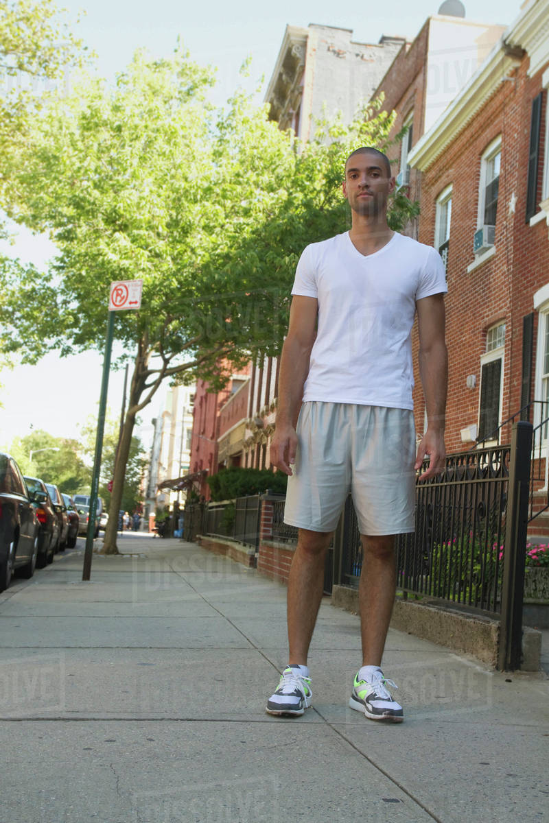 Mixed race man standing on urban sidewalk - Royalty-free Stock Photo ...