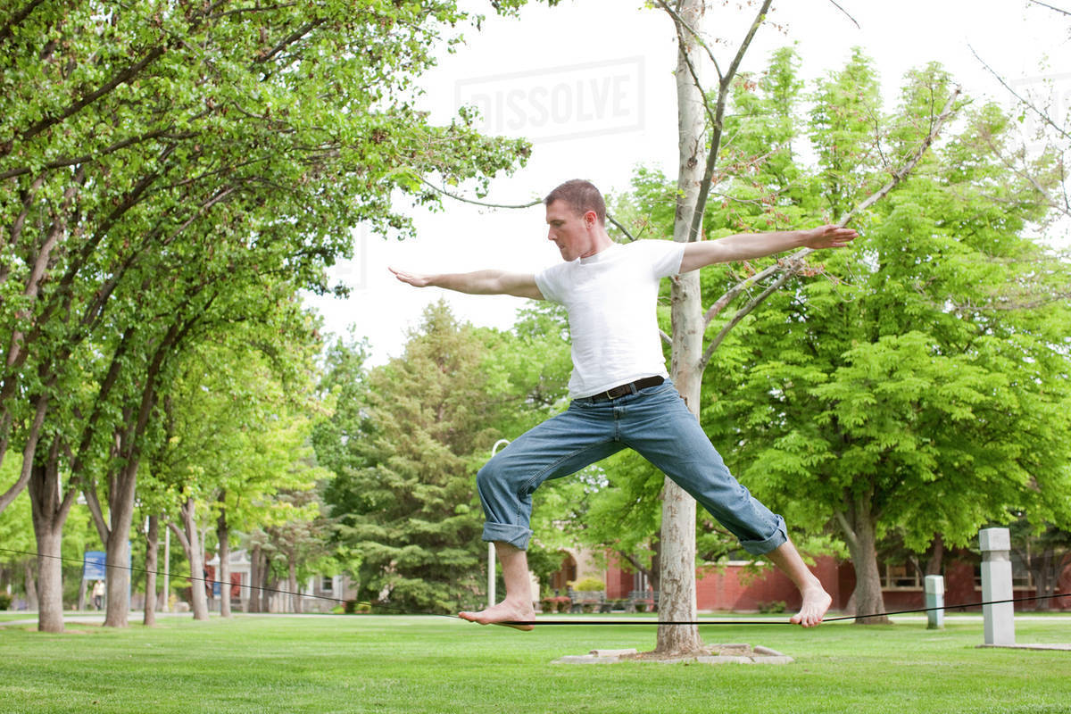 Caucasian man balancing on rope in park - Royalty-free Stock Photo ...