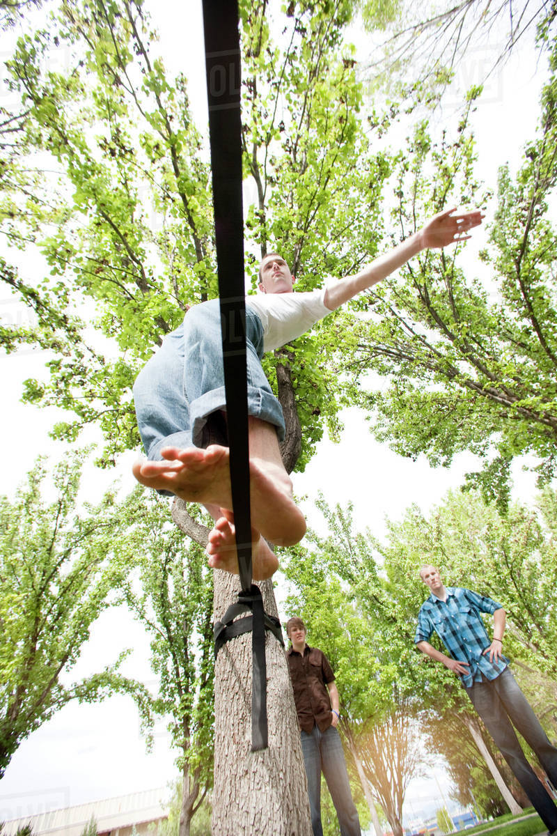 Caucasian man balancing on rope in park - Royalty-free Stock Photo ...
