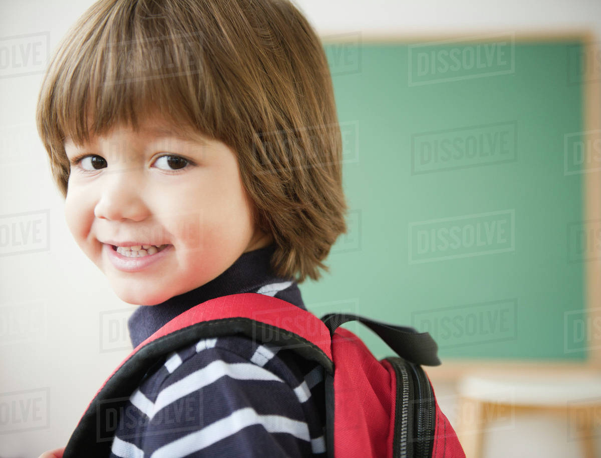 Smiling Hispanic boy wearing backpack - Royalty-free Stock Photo | Dissolve
