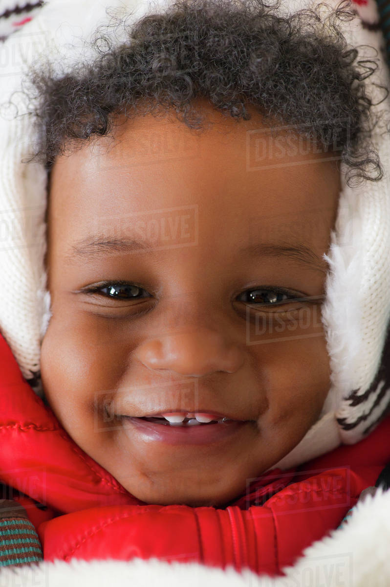 Grinning African American baby in cap - Royalty-free Stock Photo | Dissolve