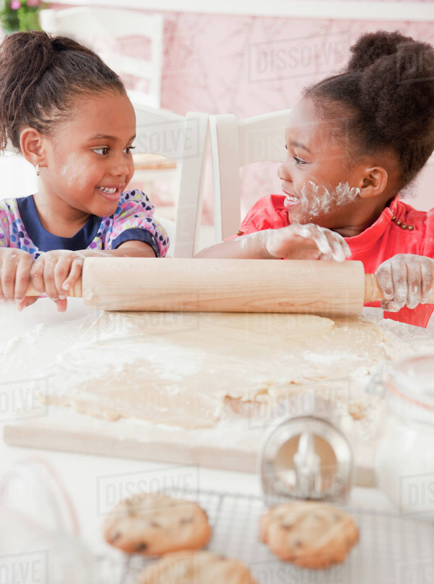 African girls making cookies - Stock Photo - Dissolve