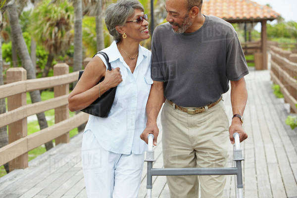 African woman walking with husband using walker - Royalty-free Stock ...
