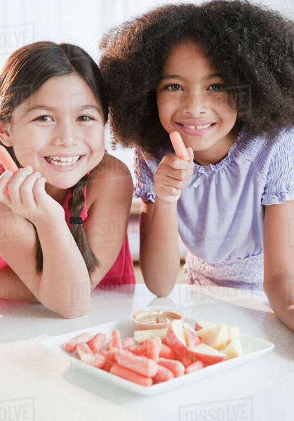 Girls eating fruits and vegetables for snack - Stock Photo - Dissolve