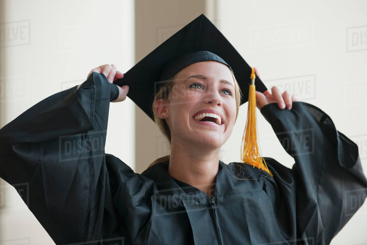 Caucasian graduate in cap and gown - Royalty-free Stock Photo | Dissolve