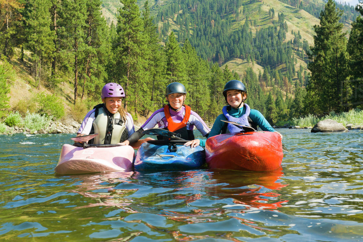 Caucasian girls kayaking in river - Royalty-free Stock Photo | Dissolve