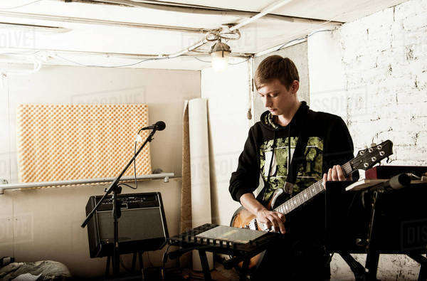 Caucasian man playing electric guitar in rock band - Royalty-free Stock ...