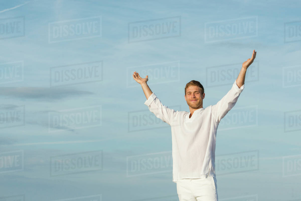 Caucasian man standing with arms raised outdoors - Royalty-free Stock ...