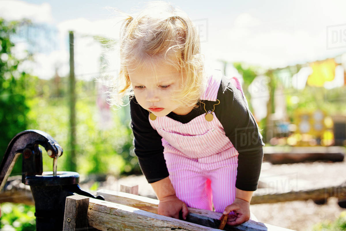 Caucasian girl peering over wooden fence - Royalty-free Stock Photo ...