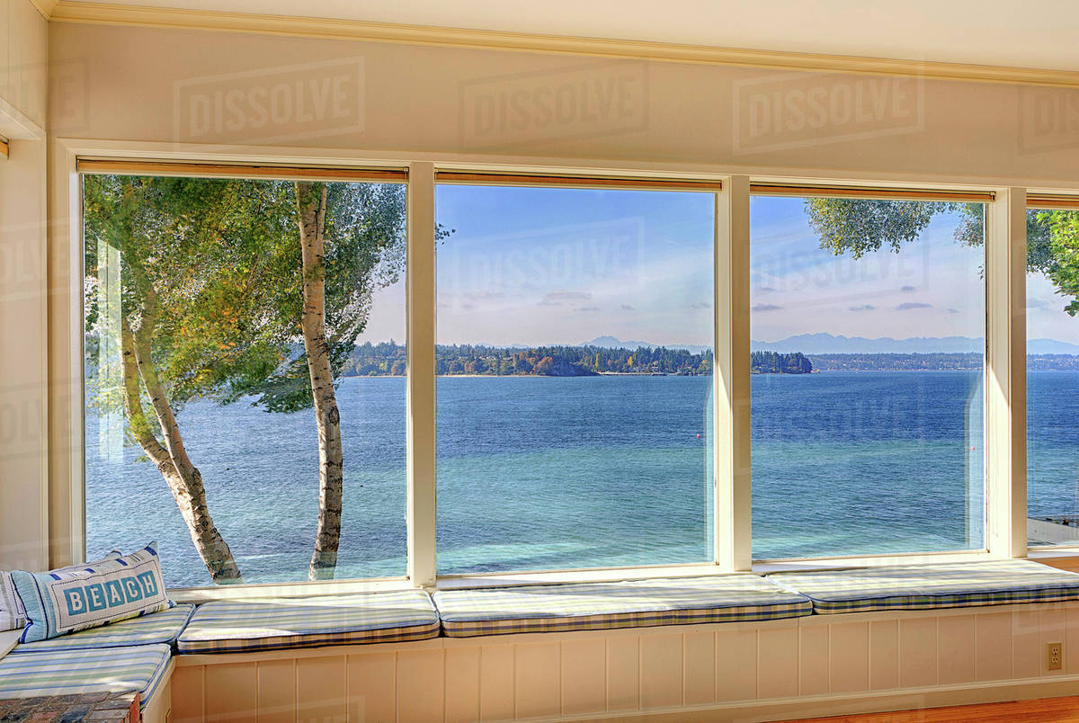 Windows to ocean view in modern living room - Stock Photo - Dissolve