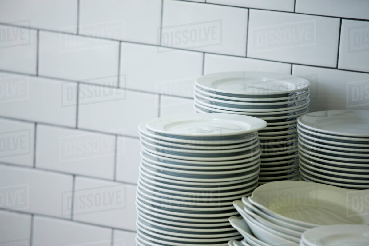 Close up of stacked plates in restaurant kitchen - Royalty-free Stock ...