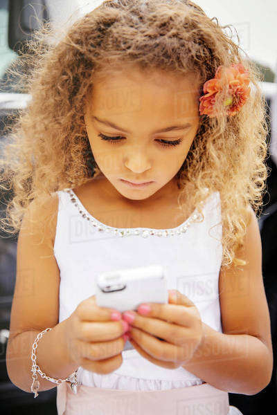 Mixed race girl using cell phone - Royalty-free Stock Photo | Dissolve