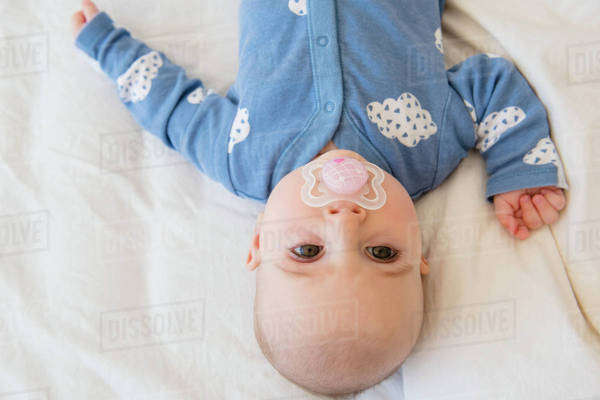 Caucasian baby girl with pacifier - Stock Photo - Dissolve