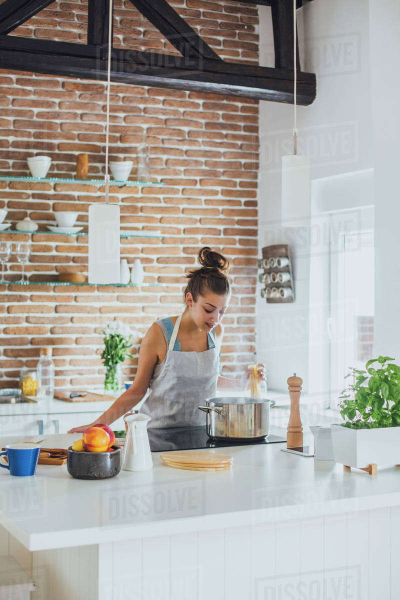 Caucasian woman cooking in kitchen - Stock Photo - Dissolve