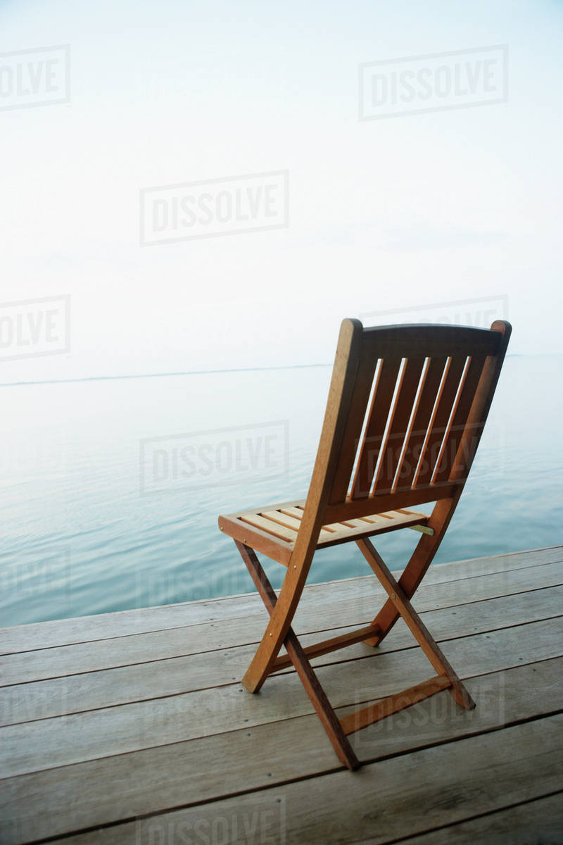 Empty deck chair on dock - Royalty-free Stock Photo | Dissolve