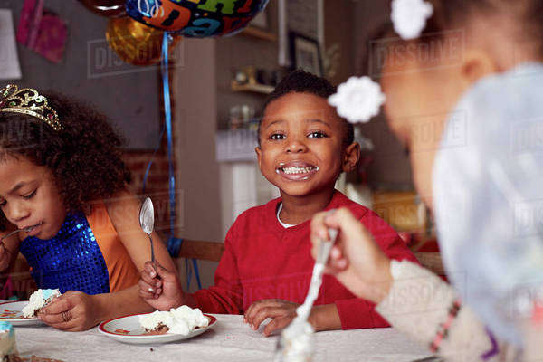 Children eating cake at party - Stock Photo - Dissolve