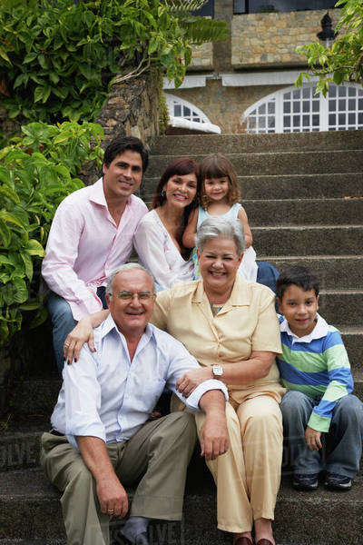 Multi-generational Hispanic family sitting on steps - Royalty-free ...