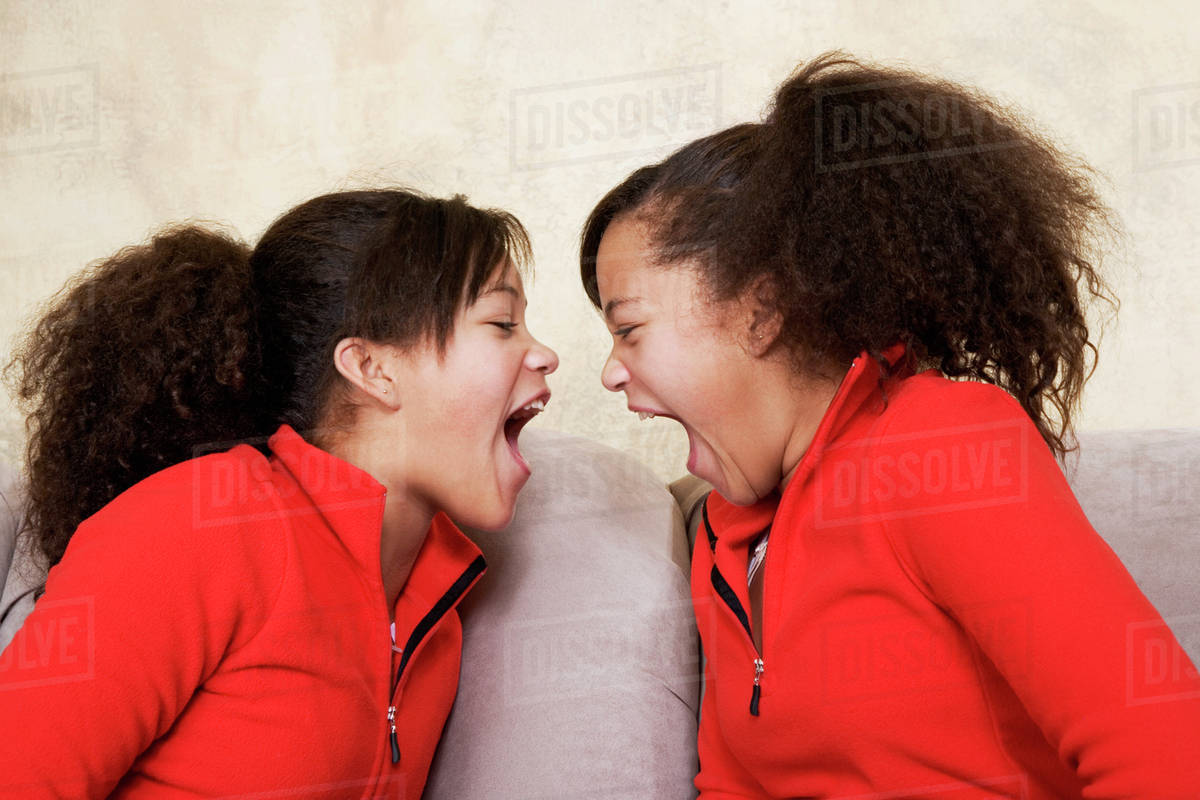 African twin sisters yelling - Royalty-free Stock Photo | Dissolve
