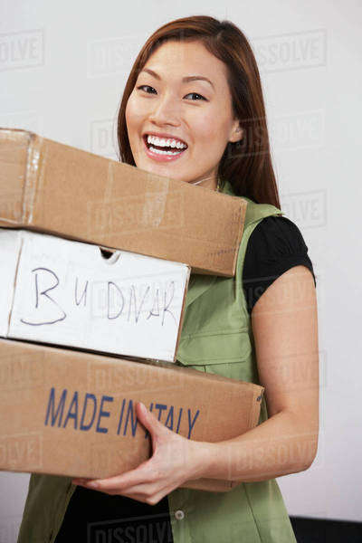 Asian woman carrying stack of packages - Royalty-free Stock Photo ...