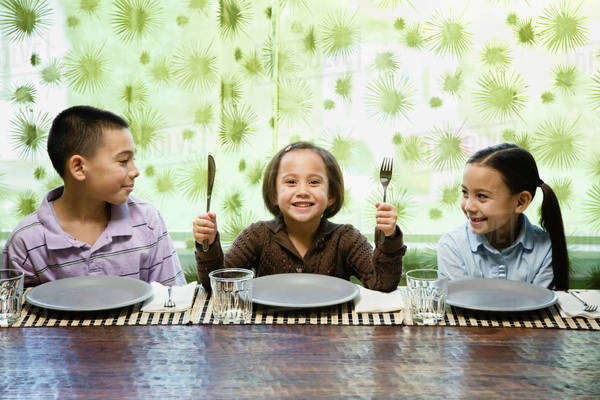 Asian siblings sitting at dinner table - Royalty-free Stock Photo ...
