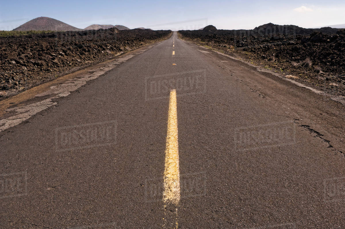 Highway through barren landscape - Royalty-free Stock Photo | Dissolve