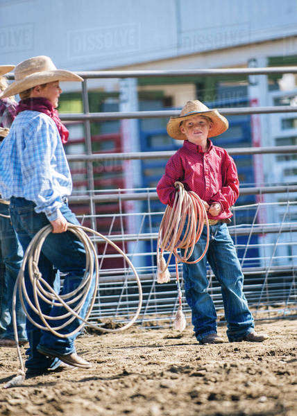 Caucasian cowboys holding lasso rope - Royalty-free Stock Photo | Dissolve