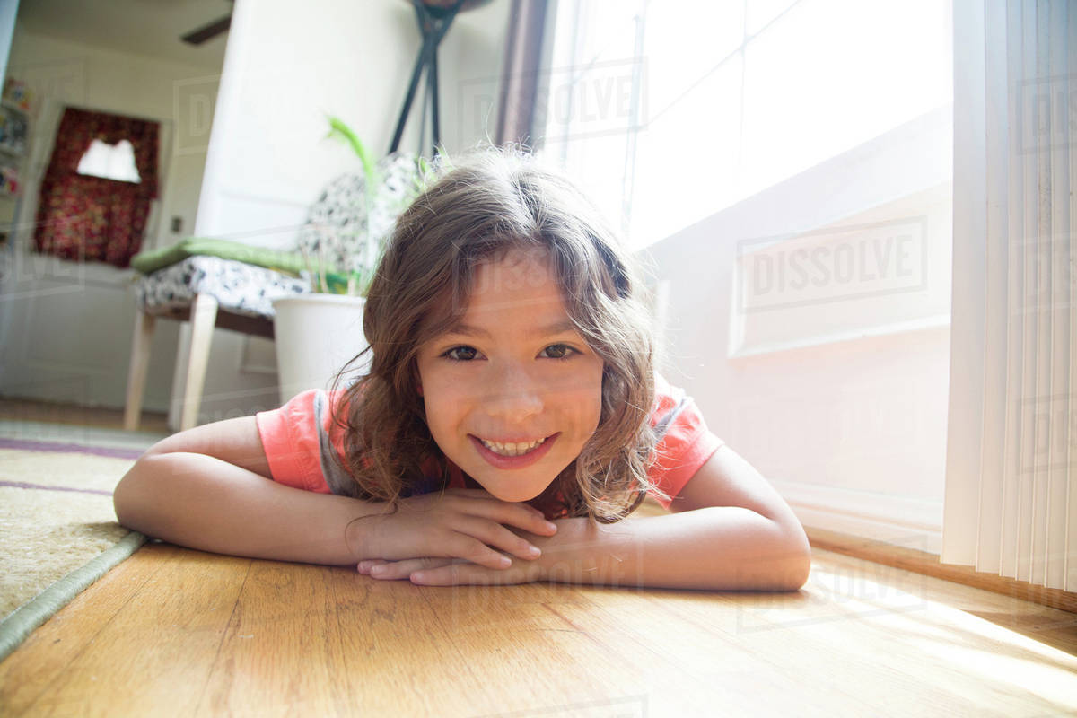 Smiling Hispanic Girl Laying On Floor Royalty Free Stock Photo Dissolve