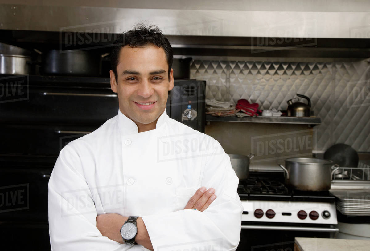 Hispanic male chef with arms crossed - Stock Photo - Dissolve