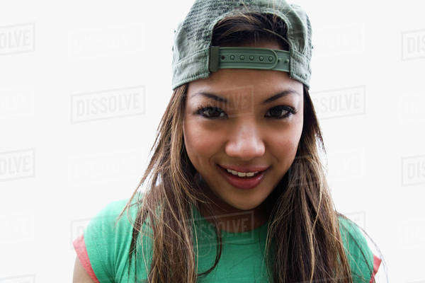 Asian woman posing in backwards cap - Stock Photo - Dissolve