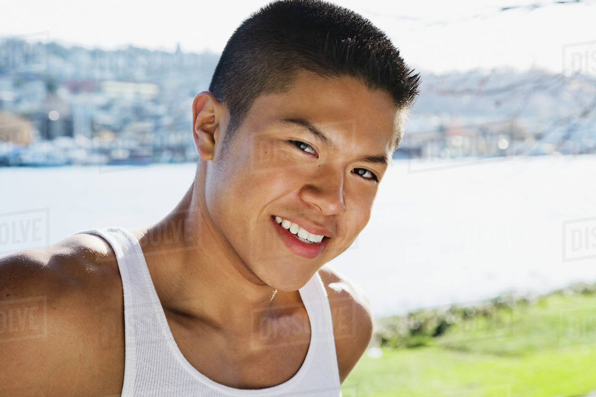 Asian man at urban waterfront - Royalty-free Stock Photo | Dissolve