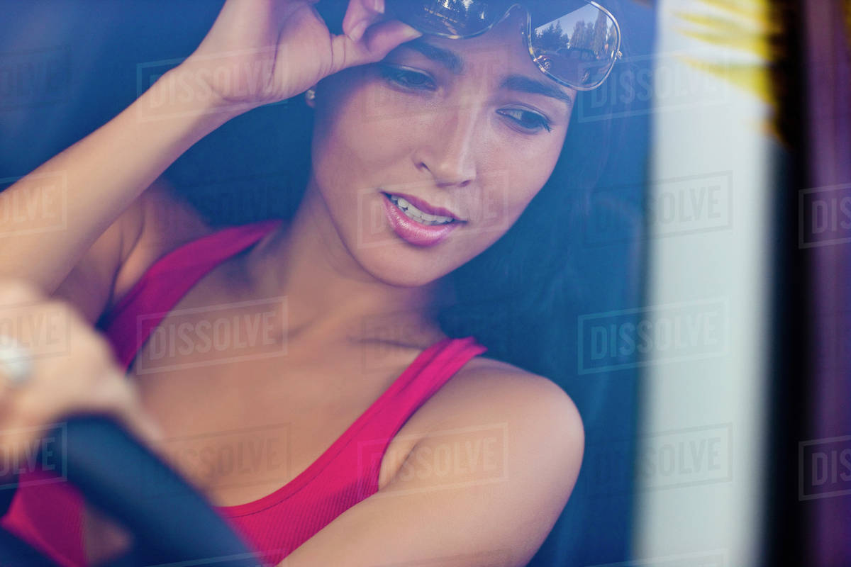 Hispanic woman driving car - Royalty-free Stock Photo | Dissolve