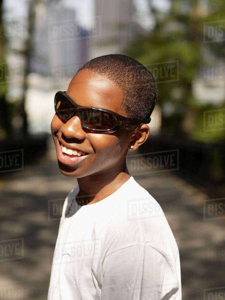 African teenage boy standing in urban park - Royalty-free Stock Photo ...