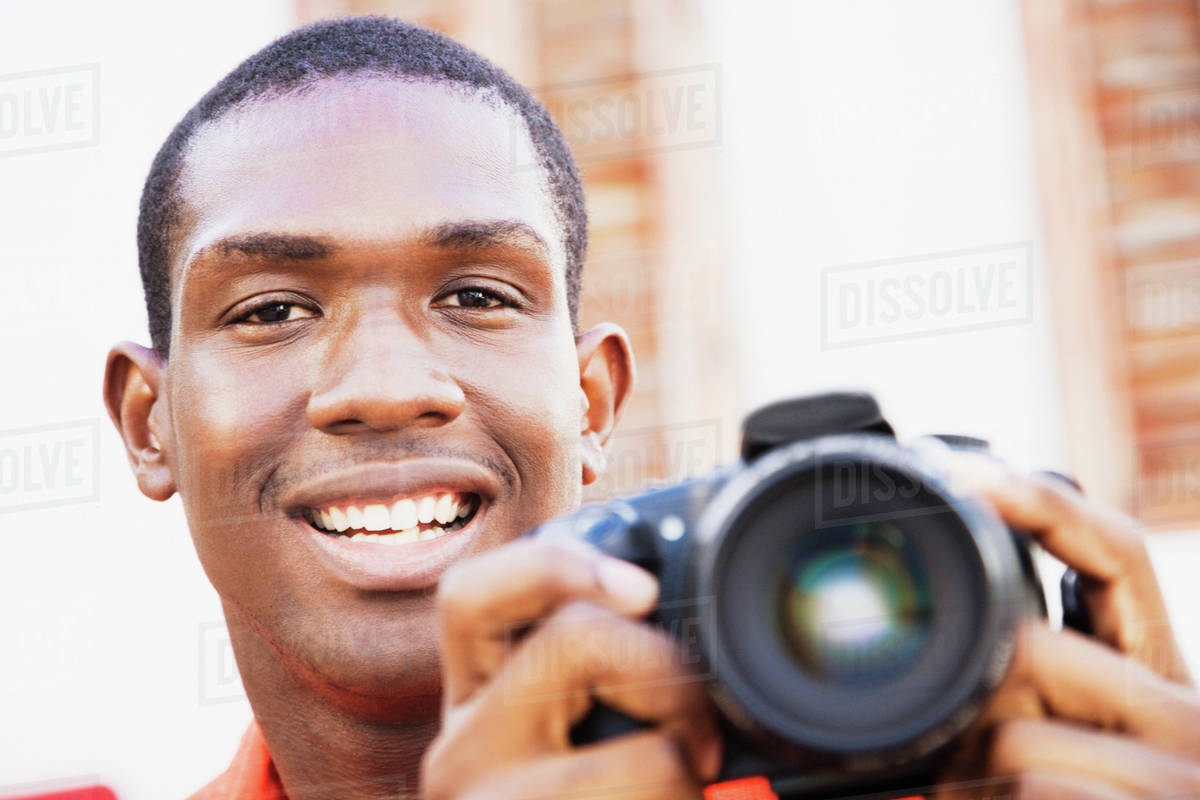 African man holding digital camera - Royalty-free Stock Photo | Dissolve