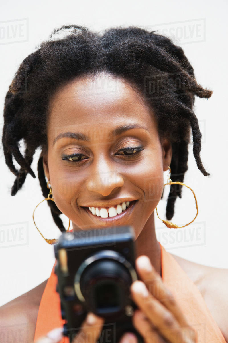 African woman holding digital camera - Royalty-free Stock Photo | Dissolve